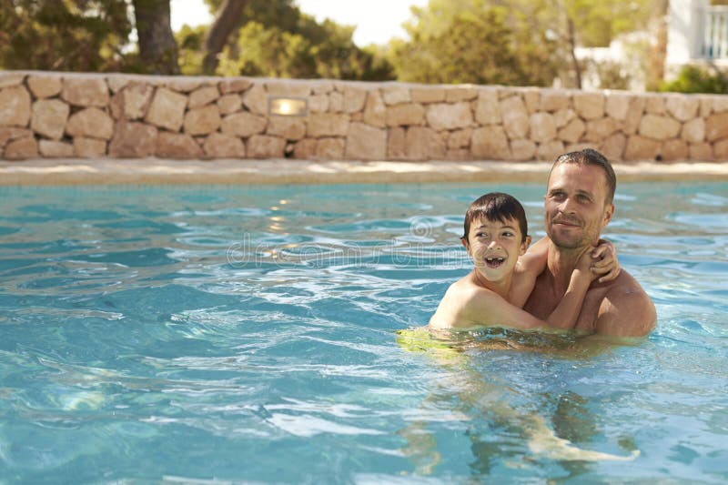 Father and Son on Vacation Having Fun in Outdoor Pool Stock Image ...