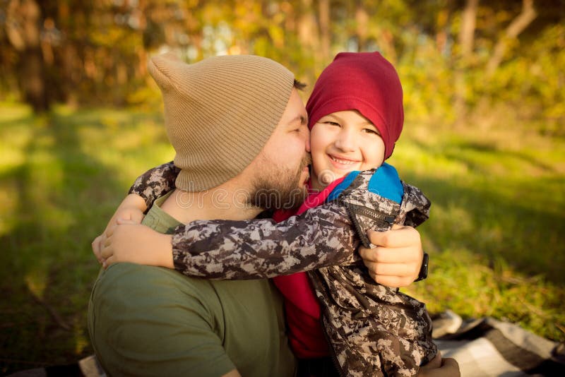 Father And Son Walking And Having Fun In Autumn Forest Look Happy And