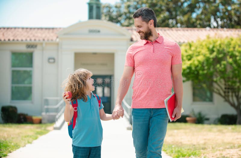 Father and Son Walking Trough School Park. Father and Son Go To School ...