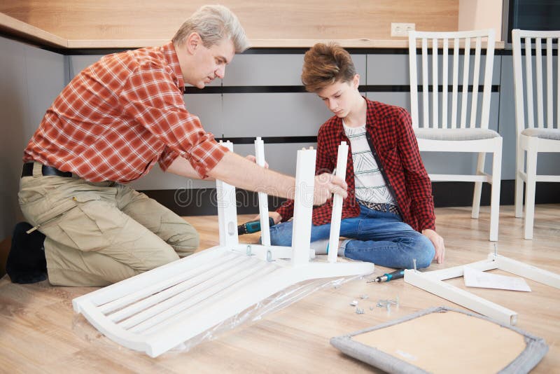 Father and Son Work Together. Kitchen Chair Assembling Stock Image ...