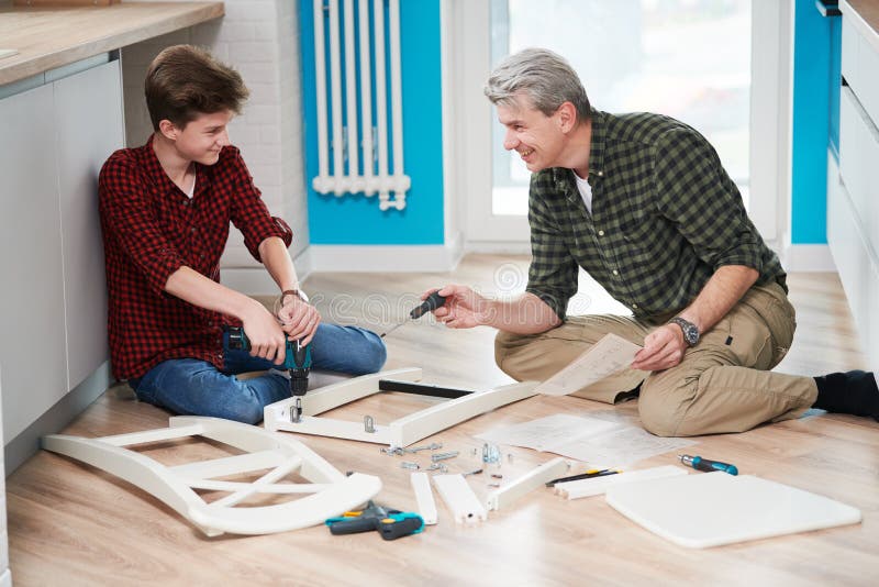 Father and Son Work Together. Kitchen Chair Assembling Stock Image ...