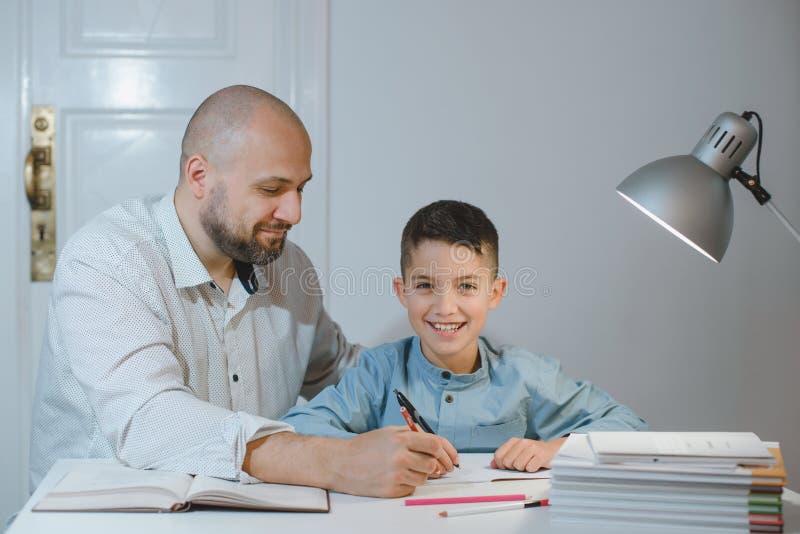 Father and Son Work Together on School Homework or Homeschooling. Stock ...