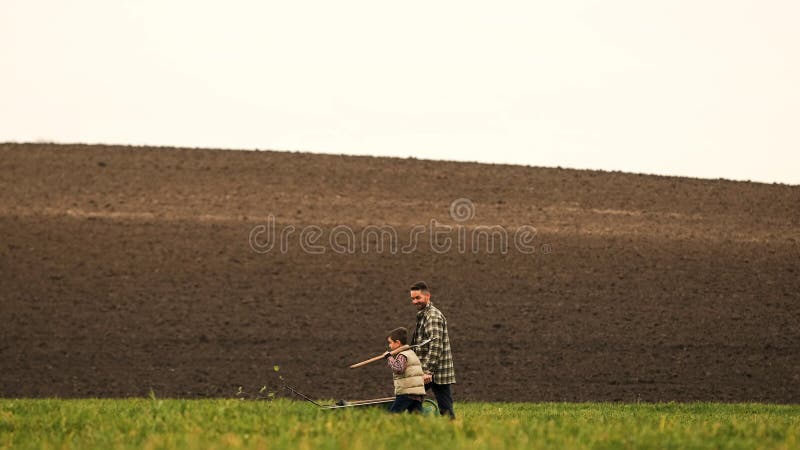 The Father and Son Working in the Field. Stock Image - Image of green ...