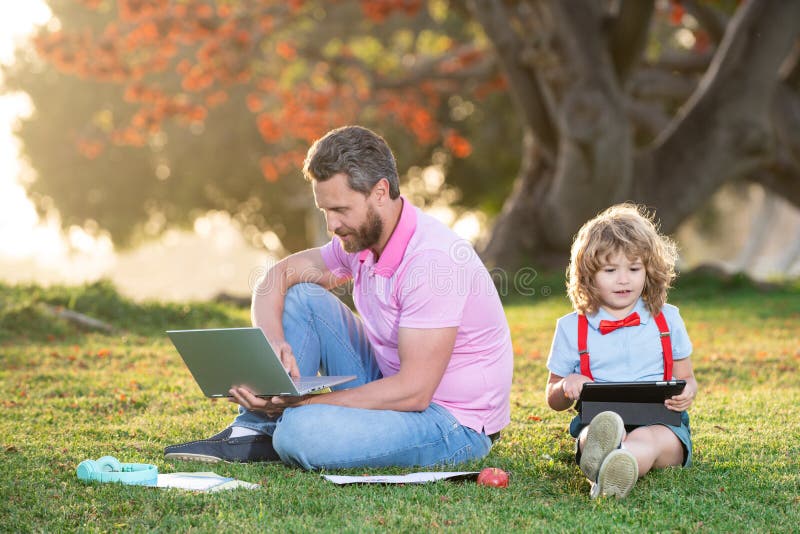 Father and Son Working with a Laptop in a School Park. Stock Image ...