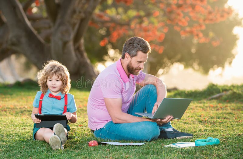 Father and Son Working with a Laptop in a School Park. Stock Photo ...