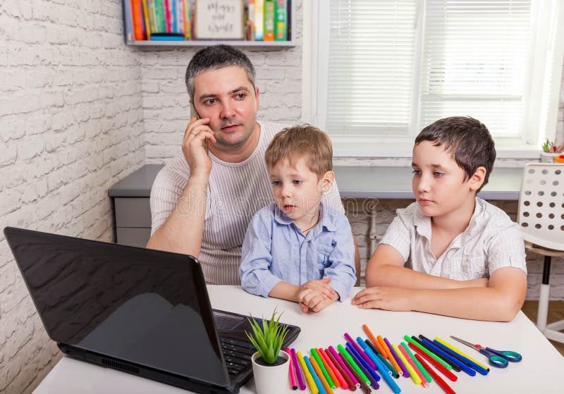 Father with Sons Working on Laptop Computer from Home. Self Isolation ...
