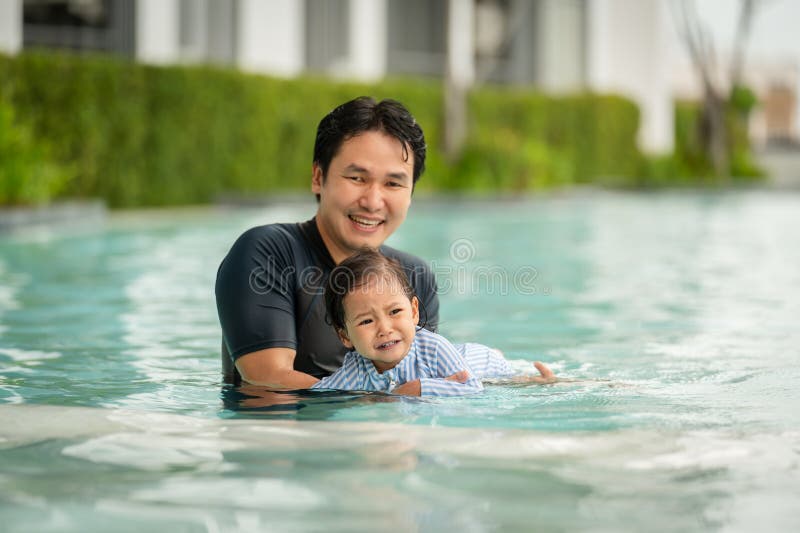 Father Teaching Crying Toddler Baby Swimming in Pool Stock Photo ...
