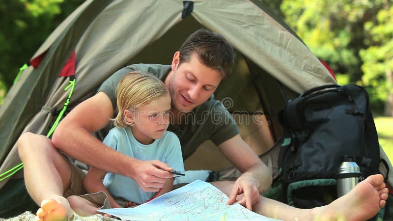 Father Teaching His Son To Read a Map Stock Footage - Video of ...