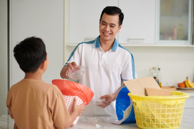 Father Teaching Son Sorting Waste Stock Photo - Image of environmental ...