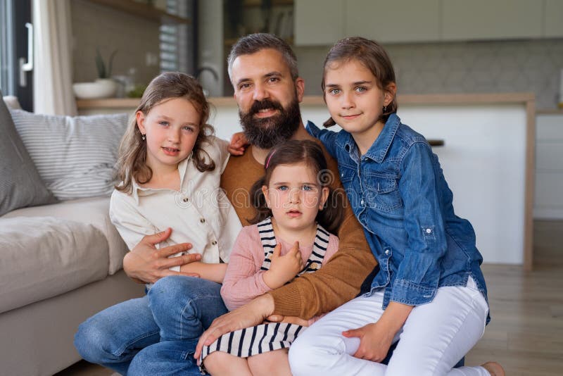 Father with Three Daughters Indoors at Home, Looking at Camera. Stock ...