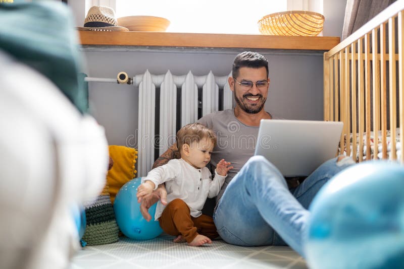 Father Trying To Work from Home with His Son Stock Photo - Image of ...