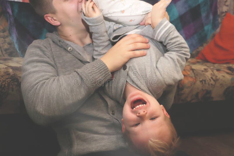 Dad and Son Play, Indulge. the Father Turned His Son Upside Down, the ... Dad and Son Play, Indulge. the Father Turned His Son Upside Down, the ...