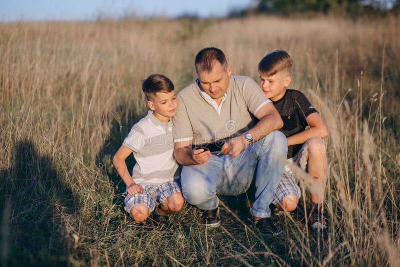 Father with two sons stock image. Image of active, cute - 121347665