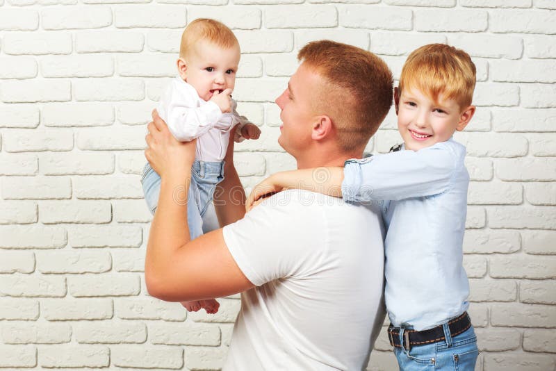 Happy Dad Hugging His Two Sons Stock Photo - Image of home, joyful ...