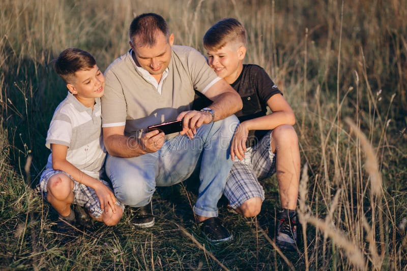 Father with two sons stock photo. Image of happiness - 123191208