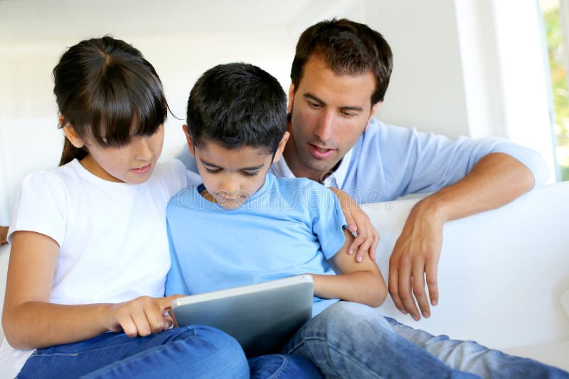 Father Watching Over Children Using Tablet Stock Image - Image of ...