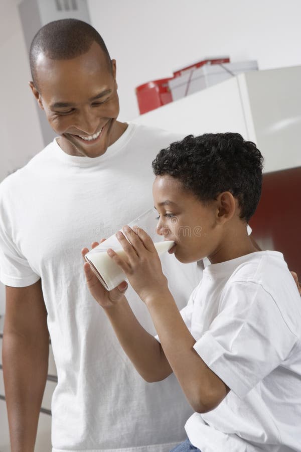 Father and Son Drinking Milk Stock Photo - Image of affection, family ...