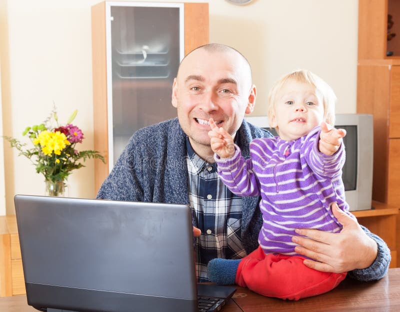 Father working with baby stock image. Image of adult - 43587575