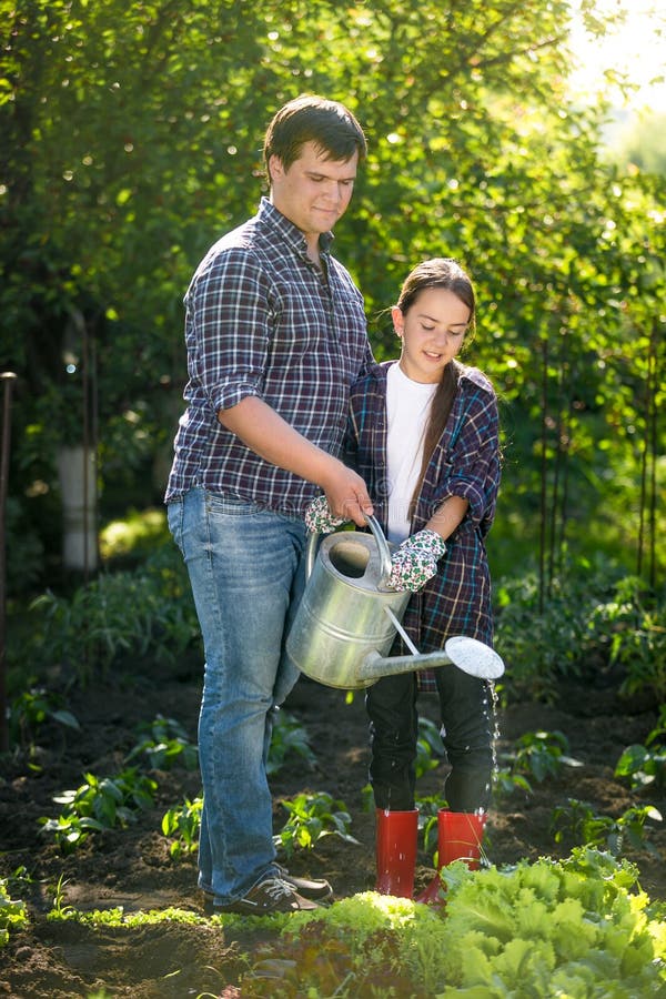 Father and Daughter Working Together in the Garden Stock Image - Image ...