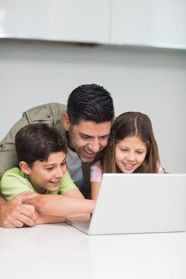 Father with Young Kids Using Laptop in Kitchen Stock Photo - Image of ...