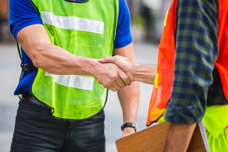 Fatory Worker Handshake with Blurred Construction Site, Success and ...