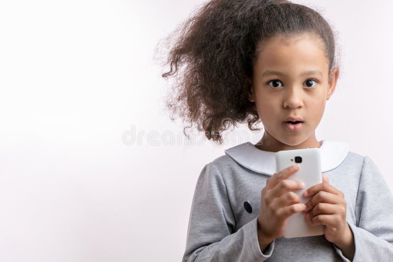 Fearful Beautiful Kid with Smart Phone Looking at the Camera Stock ...