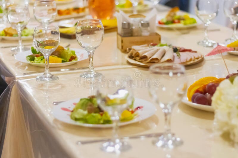 A Feast in a Cafe, a Russian Holiday, the Table is Covered with Glasses ...