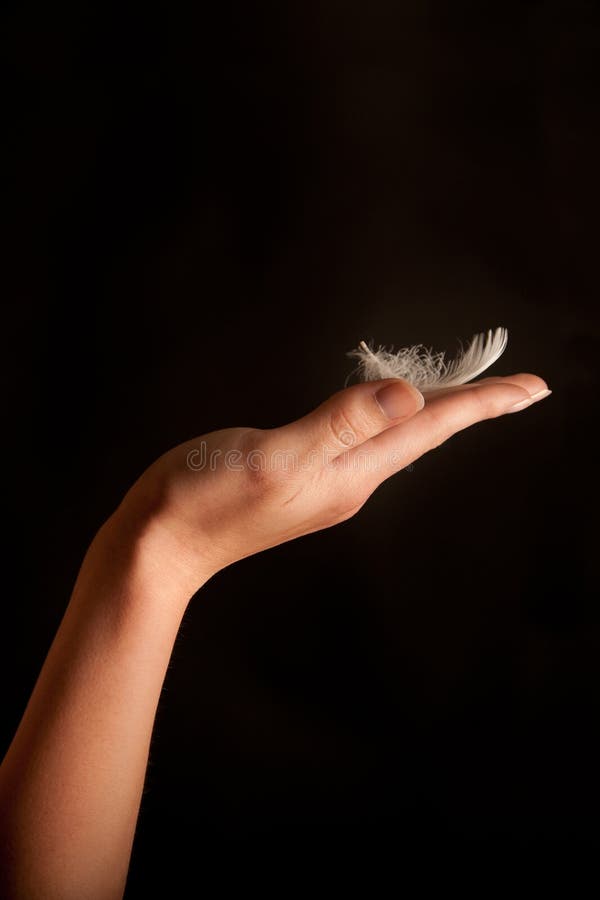 Feather on the Hand of a Woman Stock Photo - Image of body ...