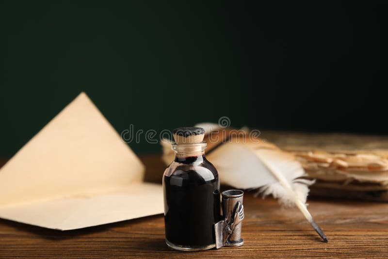 Feather Pen, Bottle of Ink and Old Paper on Wooden Table Stock Image ...