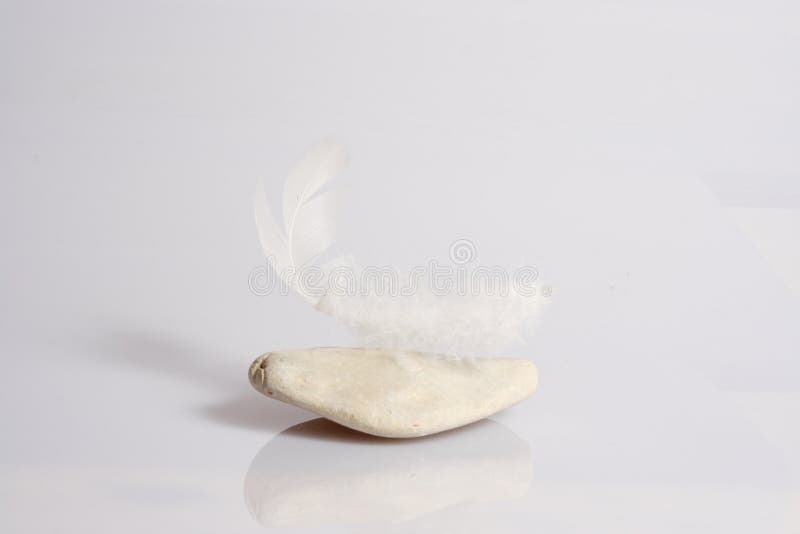 Feather and stone balance stock photo. Image of balance - 9756264