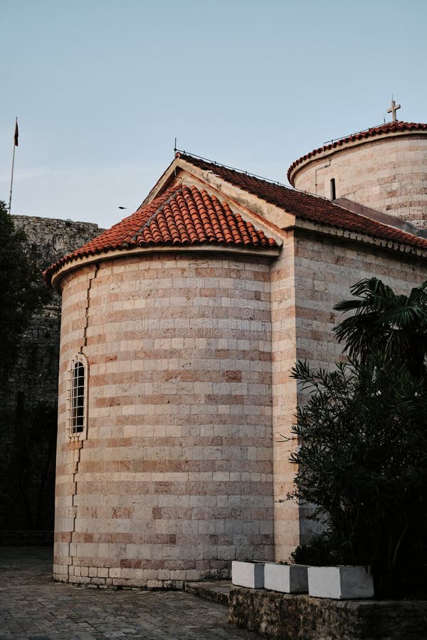 Features an Old Stone Church with a Rounded Apse and Red-tiled Roof ...