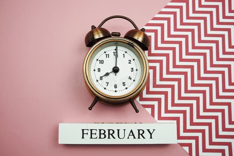 February and Alarm Clock on Pink Background Stock Photo - Image of ...