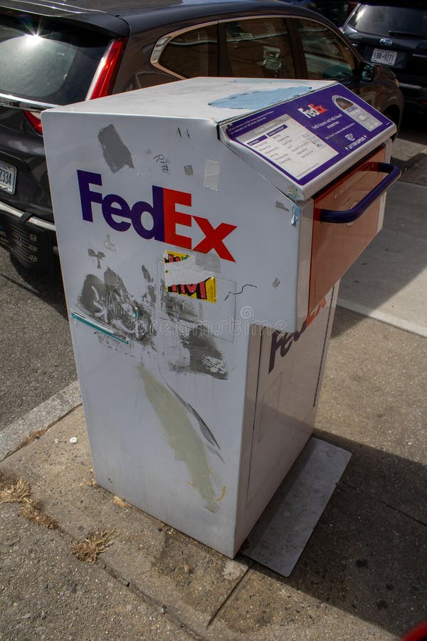 A Fedex Box and a Phone Stand on the Sidewalk Editorial Photo - Image ...