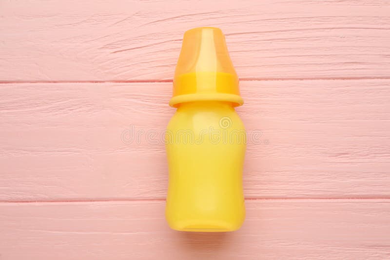 Feeding Bottle with Infant Formula on Pink Wooden Table, Top View Stock ...