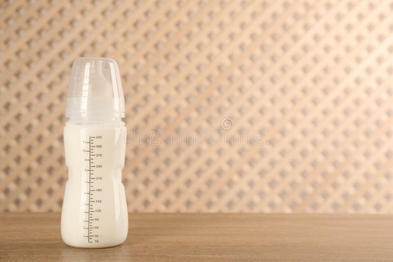 Feeding Bottle with Infant Formula on Wooden Table, Space for Text ...