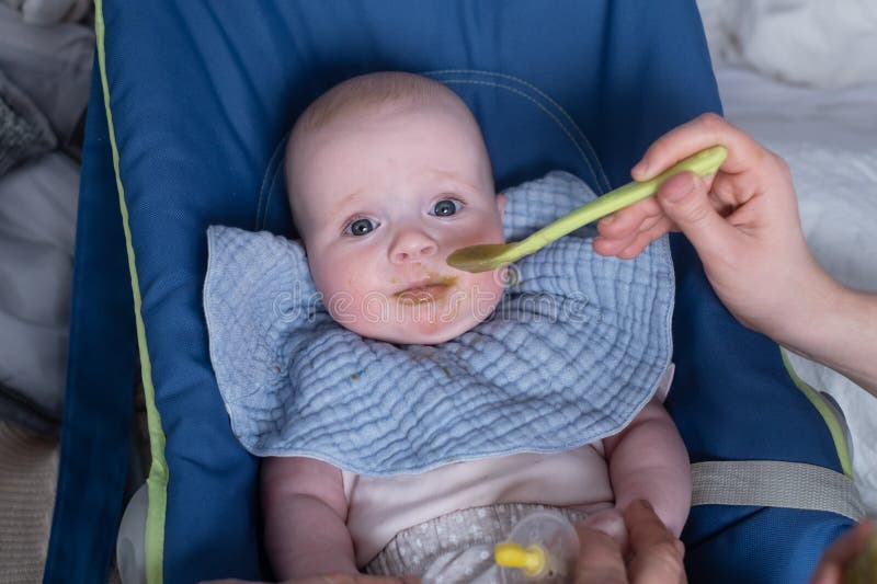 Feeding a Little Caucasian Baby for First Time. Stock Photo - Image of ...