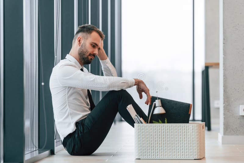 Feeling Bad, Sitting on Floor. Unemployed Man is with Personal ...