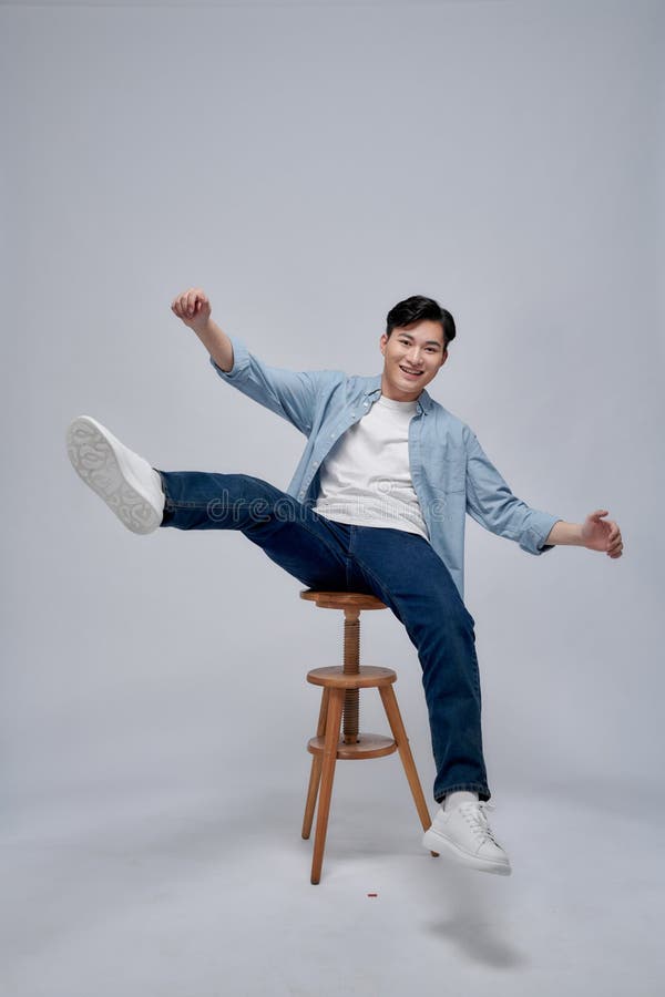 Feeling Comfortable. Joyful Positive Young Man Sitting on a Stool and ...