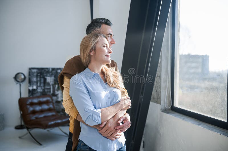 A Happy Couple Standing Together and Hugging Stock Photo - Image of ...