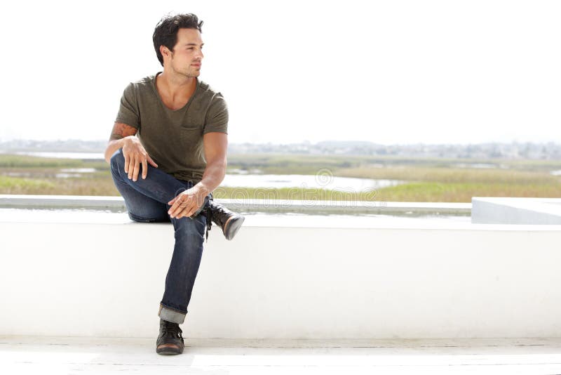 Feeling Relaxed. a Handsome Young Man Looking Thoughtful while Sitting ...