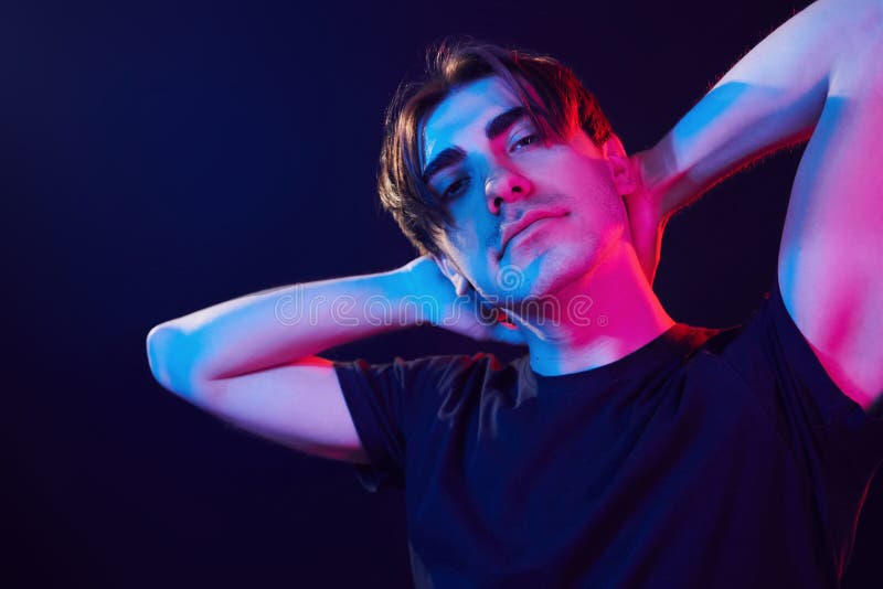 Feeling Relaxed. Man Standing in the Studio with Neon Light Stock Image ...