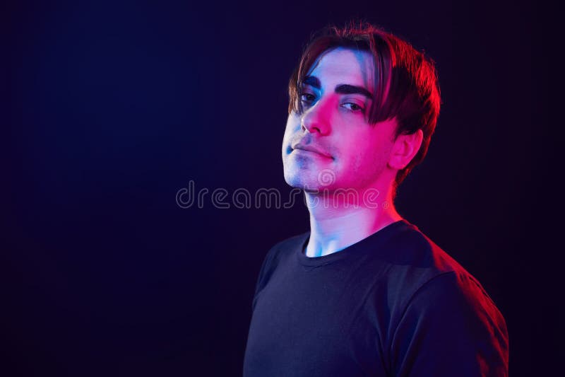 Feeling Relaxed. Man Standing in the Studio with Neon Light Stock Photo ...
