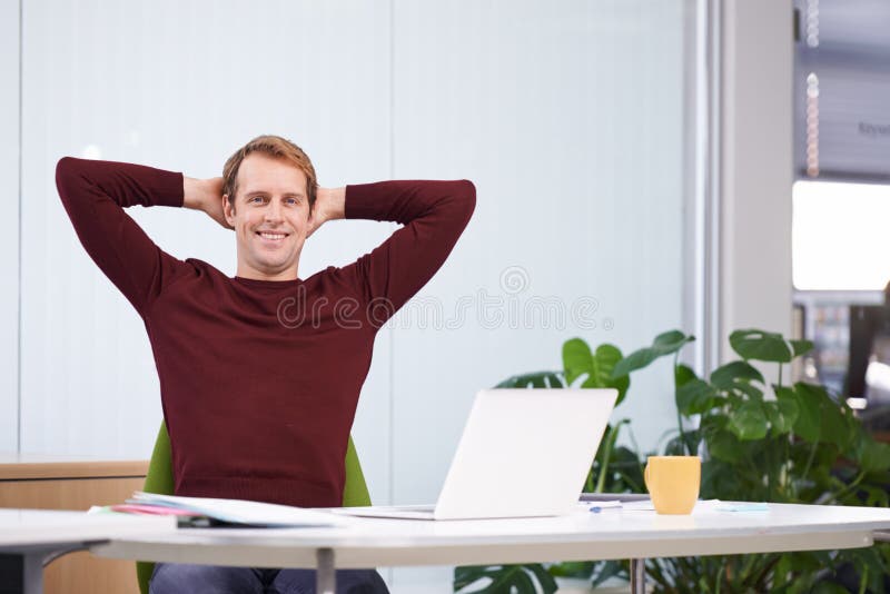Feeling Relaxed about Work. a Handsome Businessman Working at His Desk ...