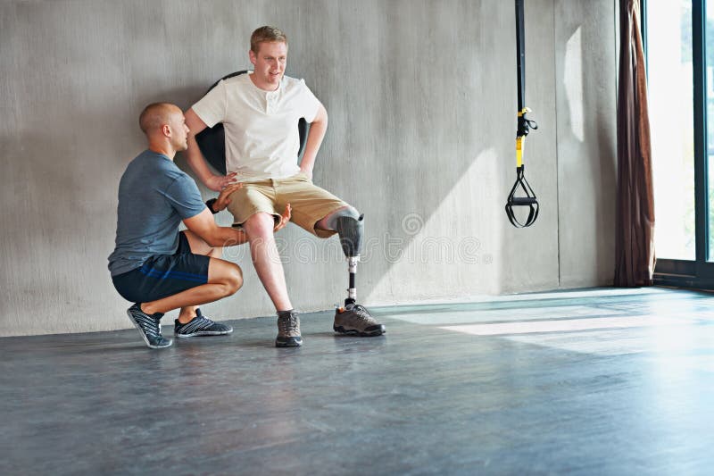 Feeling Stable yet. Studio Shot of a Young Amputee Training in a Gym ...