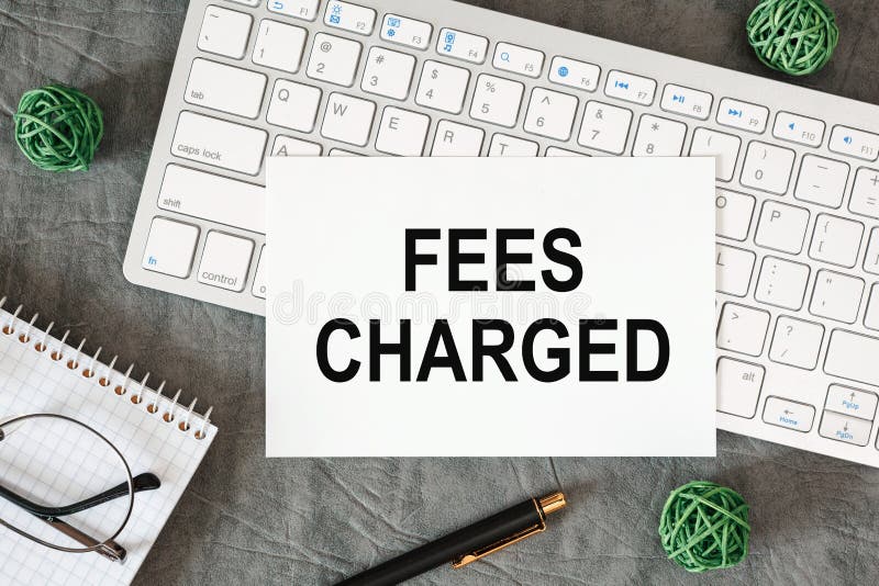 FEES CHARGED is Written in a Document on the Office Desk with Keyboard ...