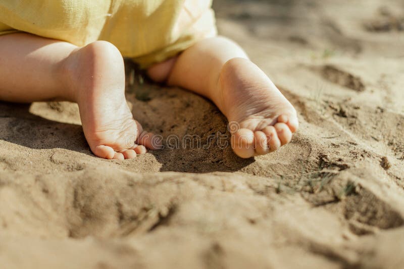 Feet of a Child Crawling on the Sand Stock Image - Image of game ...