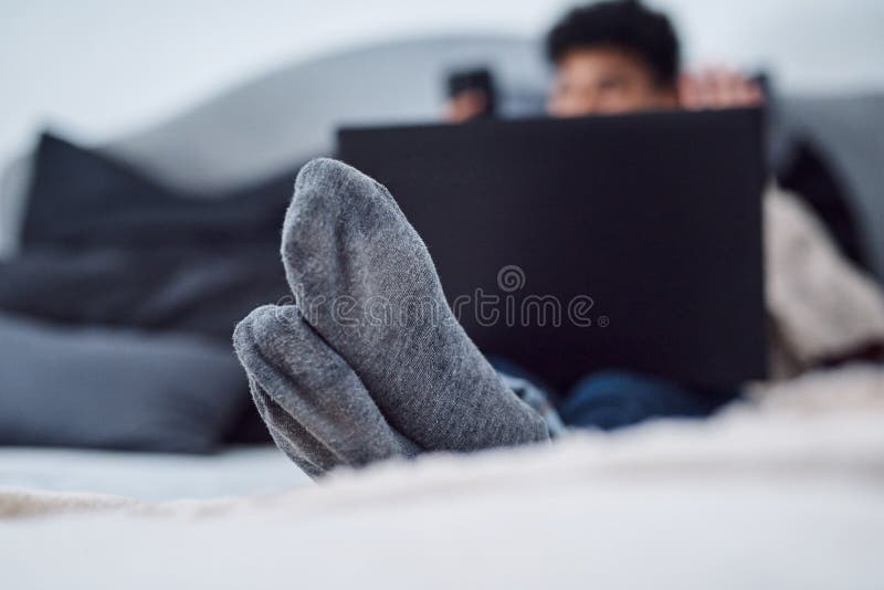 Feet, Laptop and Relax with Person on Bed in Home for Weekend Browsing ...