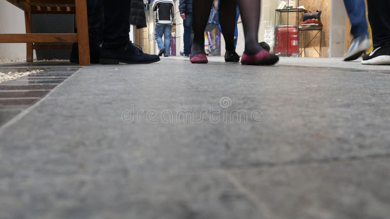 People Walking in Front of Fashion Shop in Mall. Feet of People Walking ...