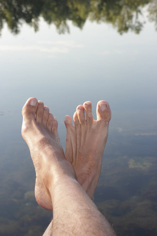Feet Relaxing Over Water Reflection Stock Photo - Image of summer ...
