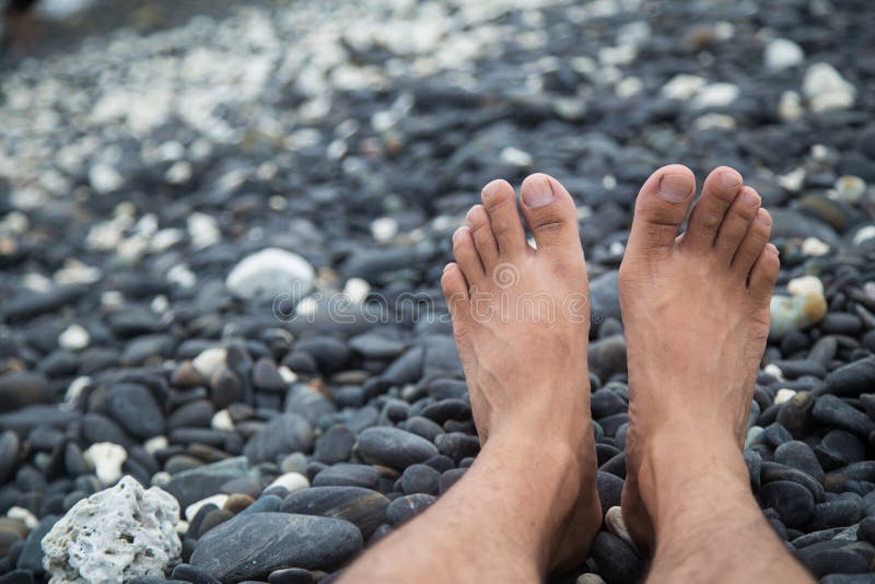 Feet on the rock seashore stock photo. Image of rock - 79089450